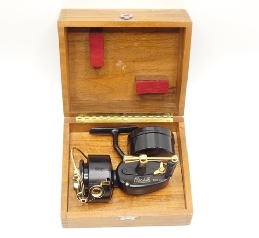 A fine Mitchell 300DL fixed spool reel and teak case, gold plated ...